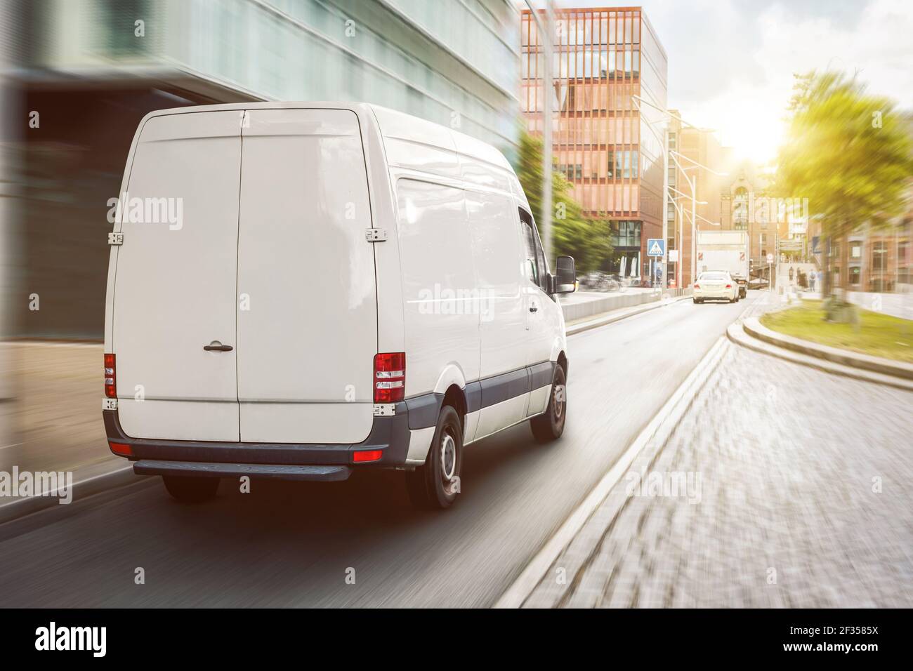 Cargo van driving in the city Stock Photo - Alamy