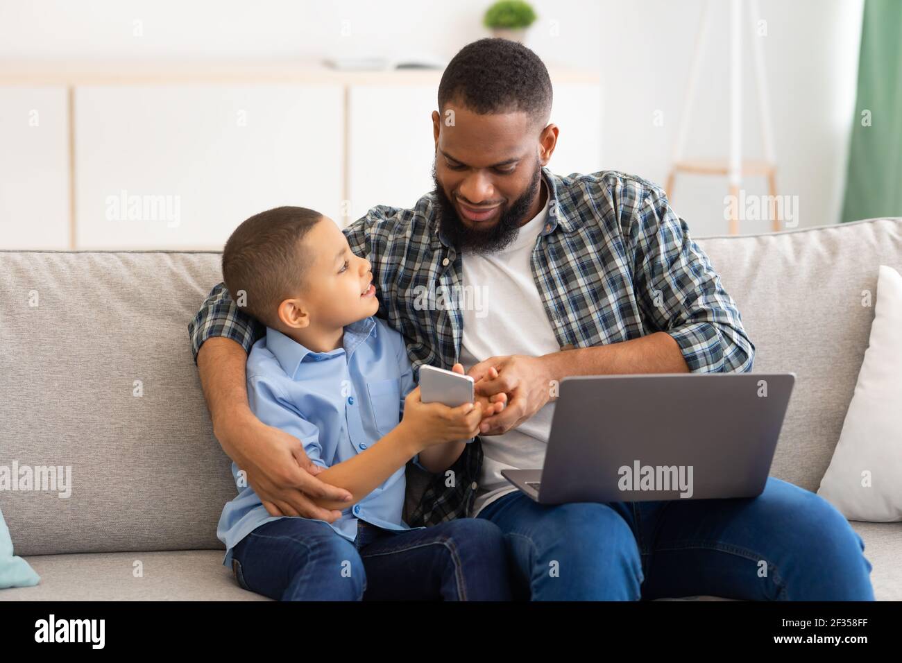 Father using smartphone background hi-res stock photography and images ...