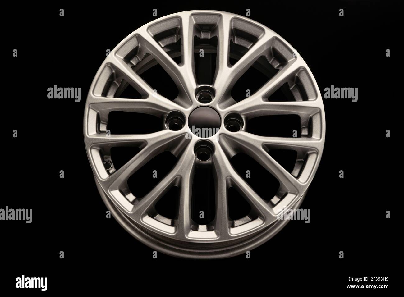 new grey silver alloy wheel on black background Stock Photo - Alamy