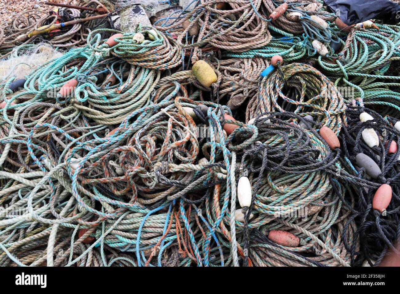 Tangled pile of ropes and floats Stock Photo - Alamy