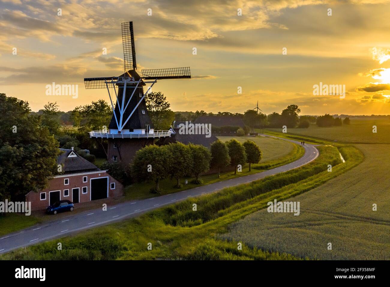 Historic windmill at a farm in agricultural landscape on the ...
