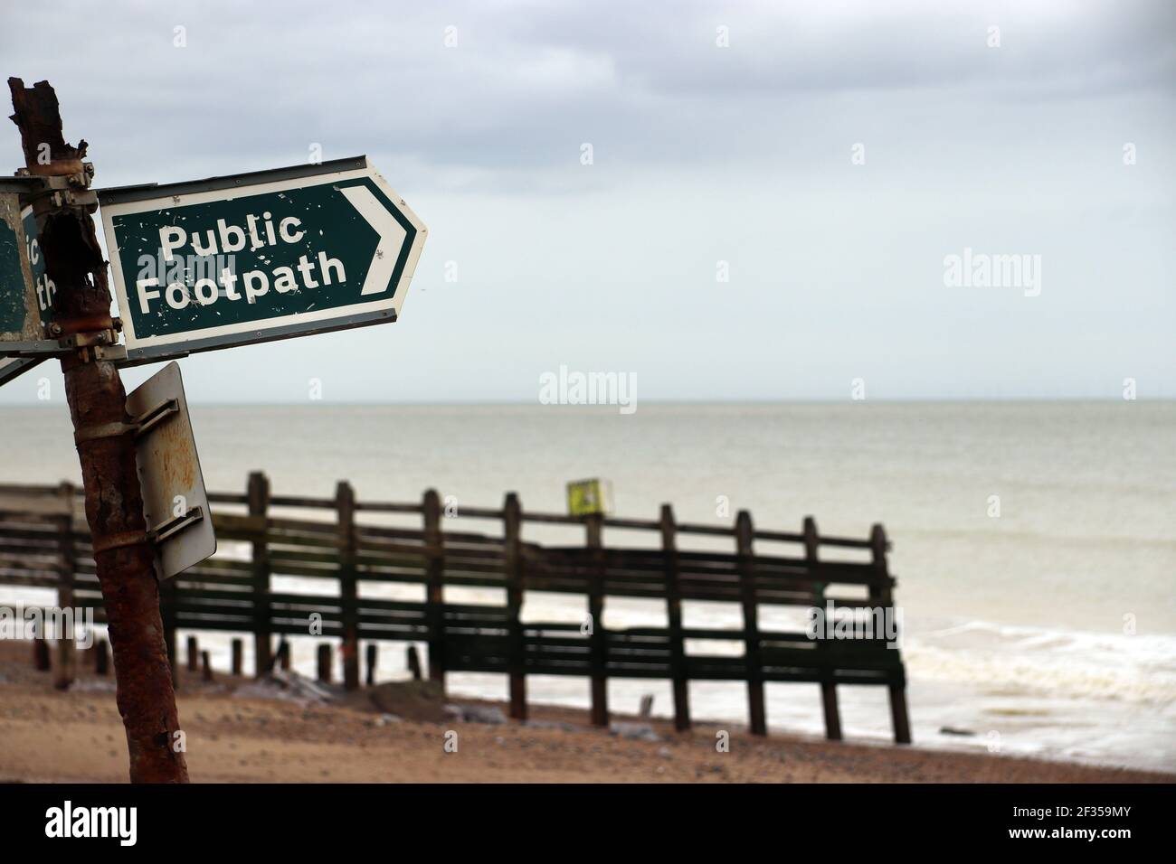 Public Footpath sign in Sussex pointing into the sea , England, UK ...