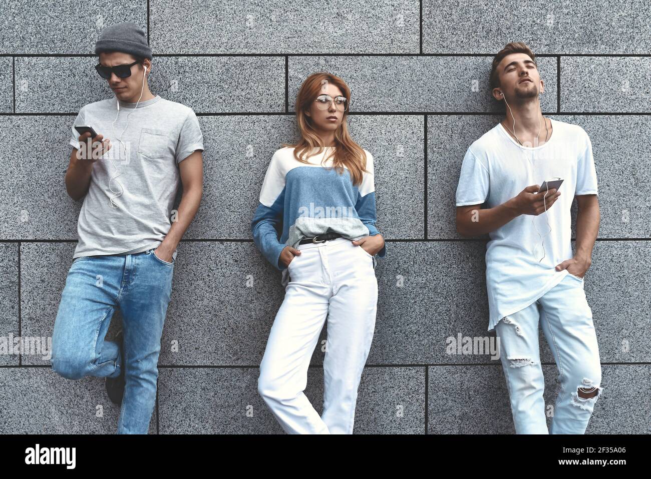 Fashion portrait of Three best friends posing at street, wearing ...
