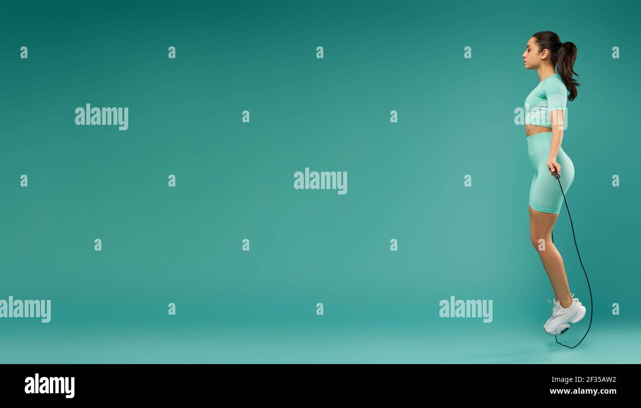 Website header of Sporty young woman jumping over skipping rope Stock ...