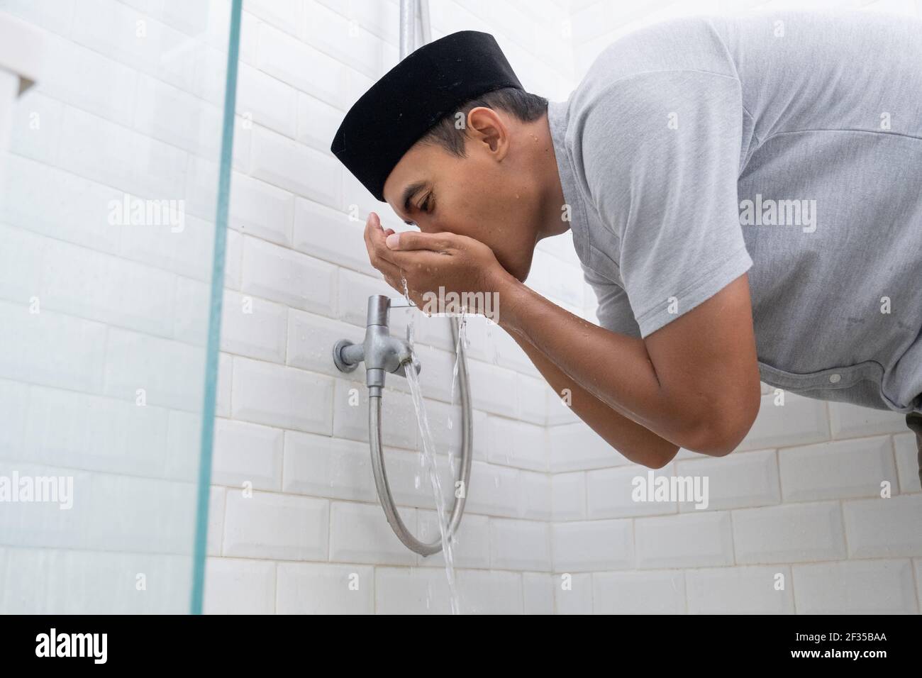 Young Muslim man perform ablution wudhu before prayer at home Stock ...