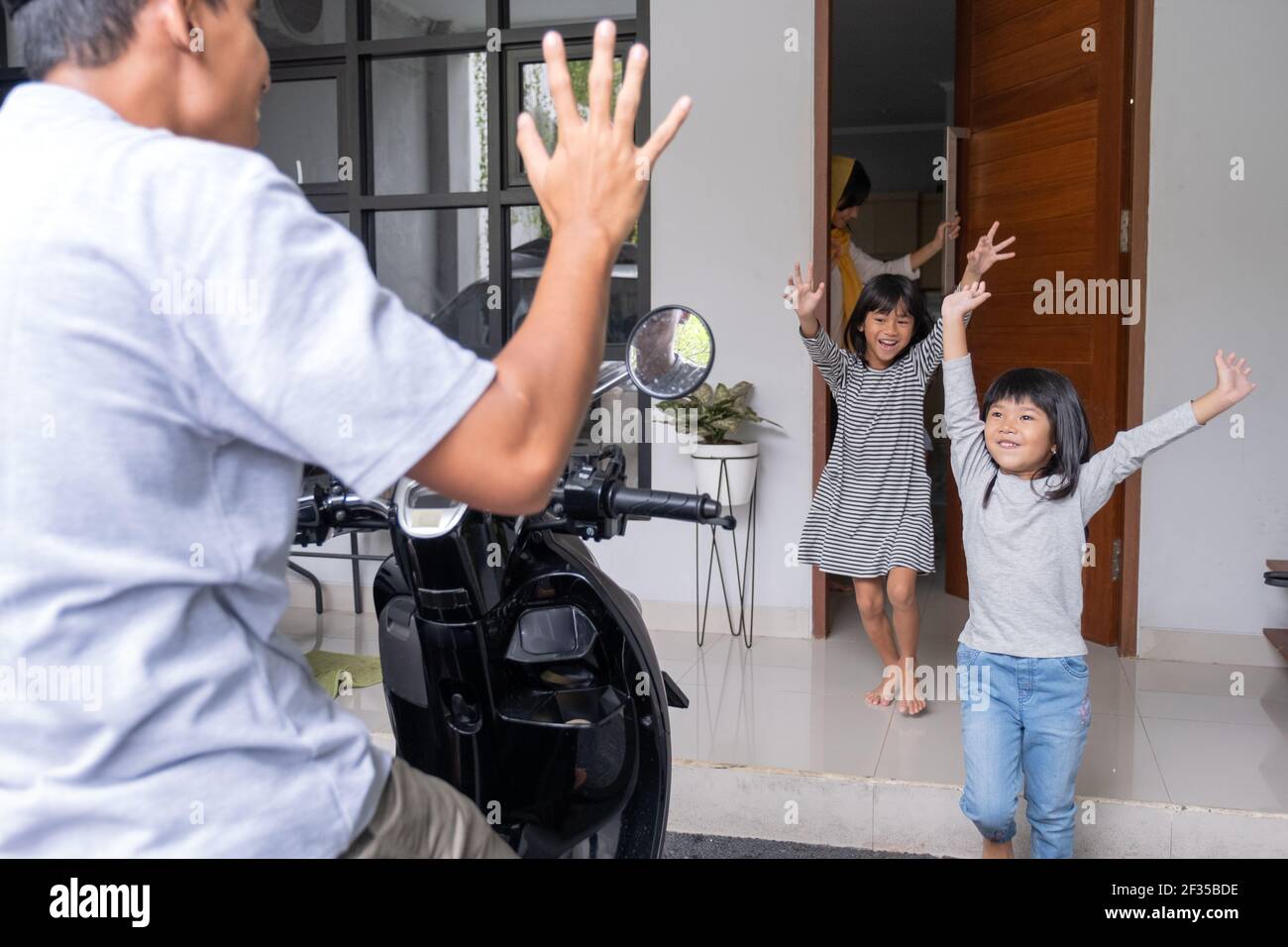 muslim asian father going back home from work being welcome by his ...