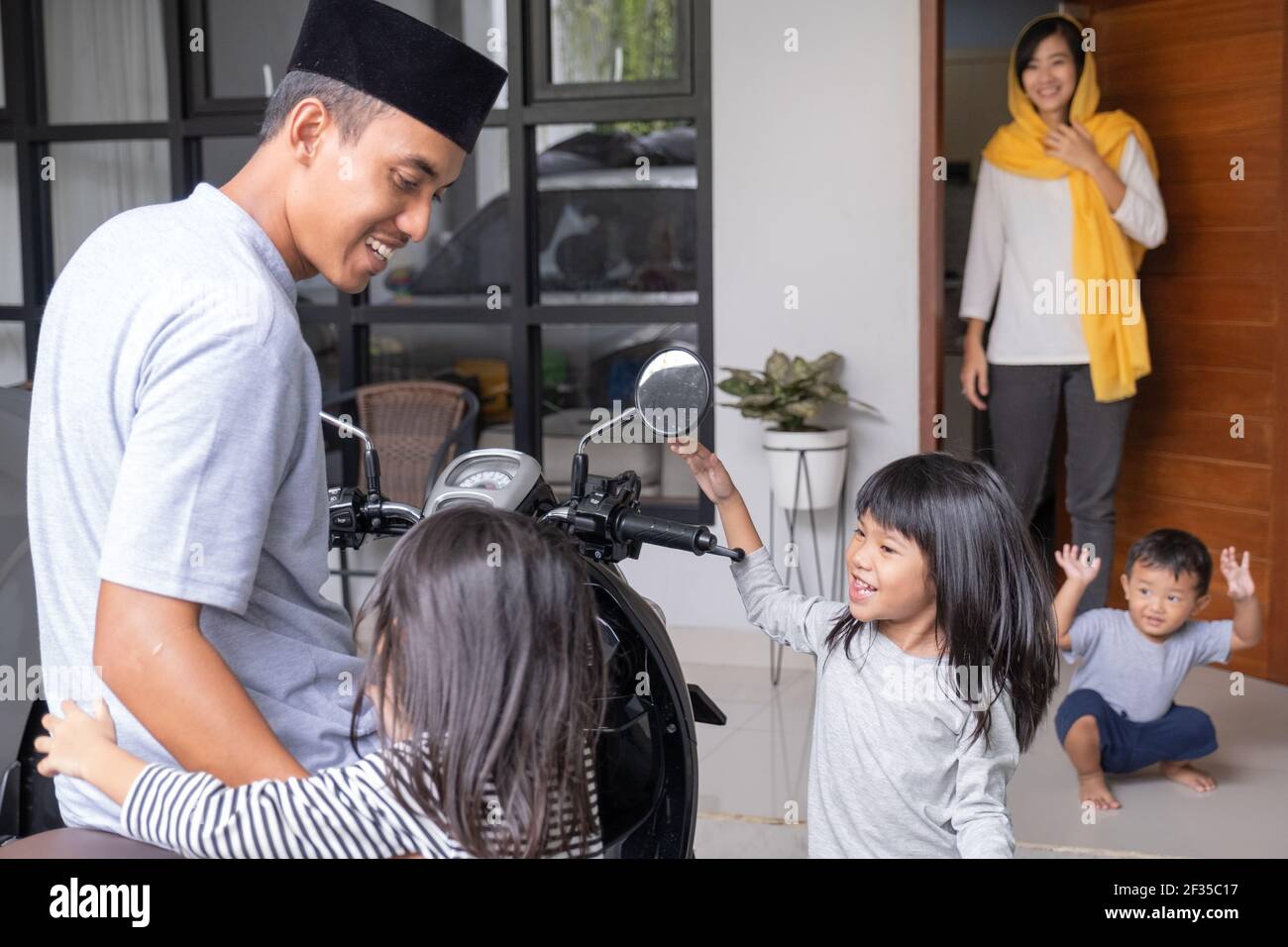 muslim asian father going back home from work being welcome by his ...