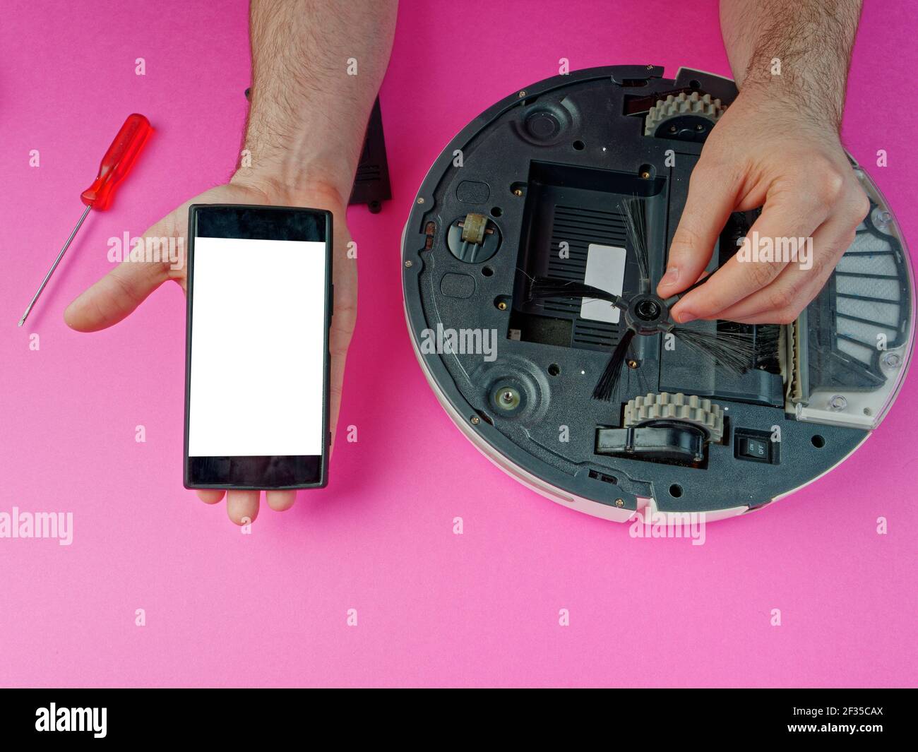 The robot vacuum cleaner is disassembled, the vacuum cleaner is being ...