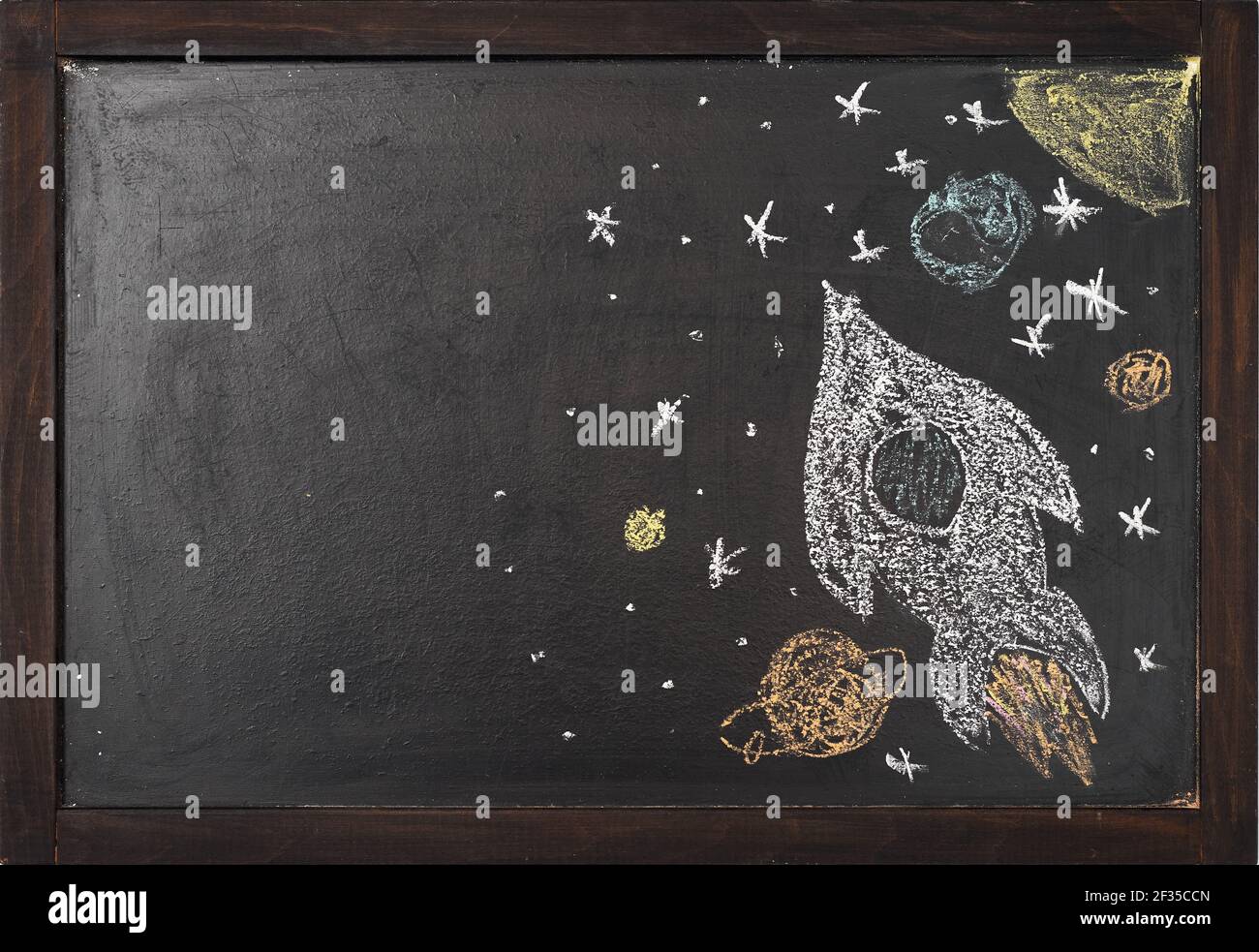 a rocket with planets is drawn on a chalk board Stock Photo - Alamy
