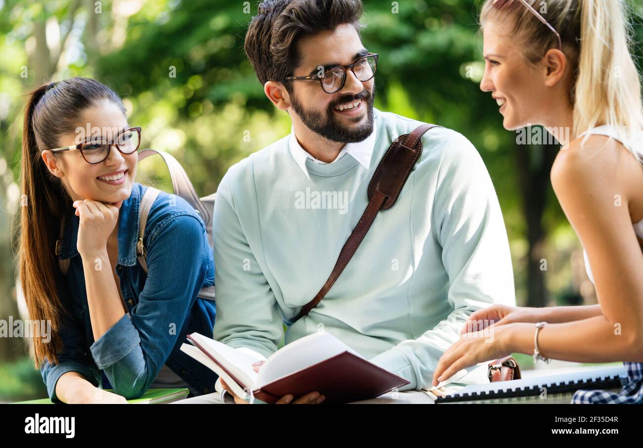 Group of happy university students studying together and having fun ...