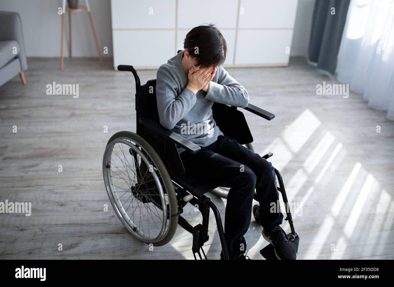 Sad Child In Wheelchair