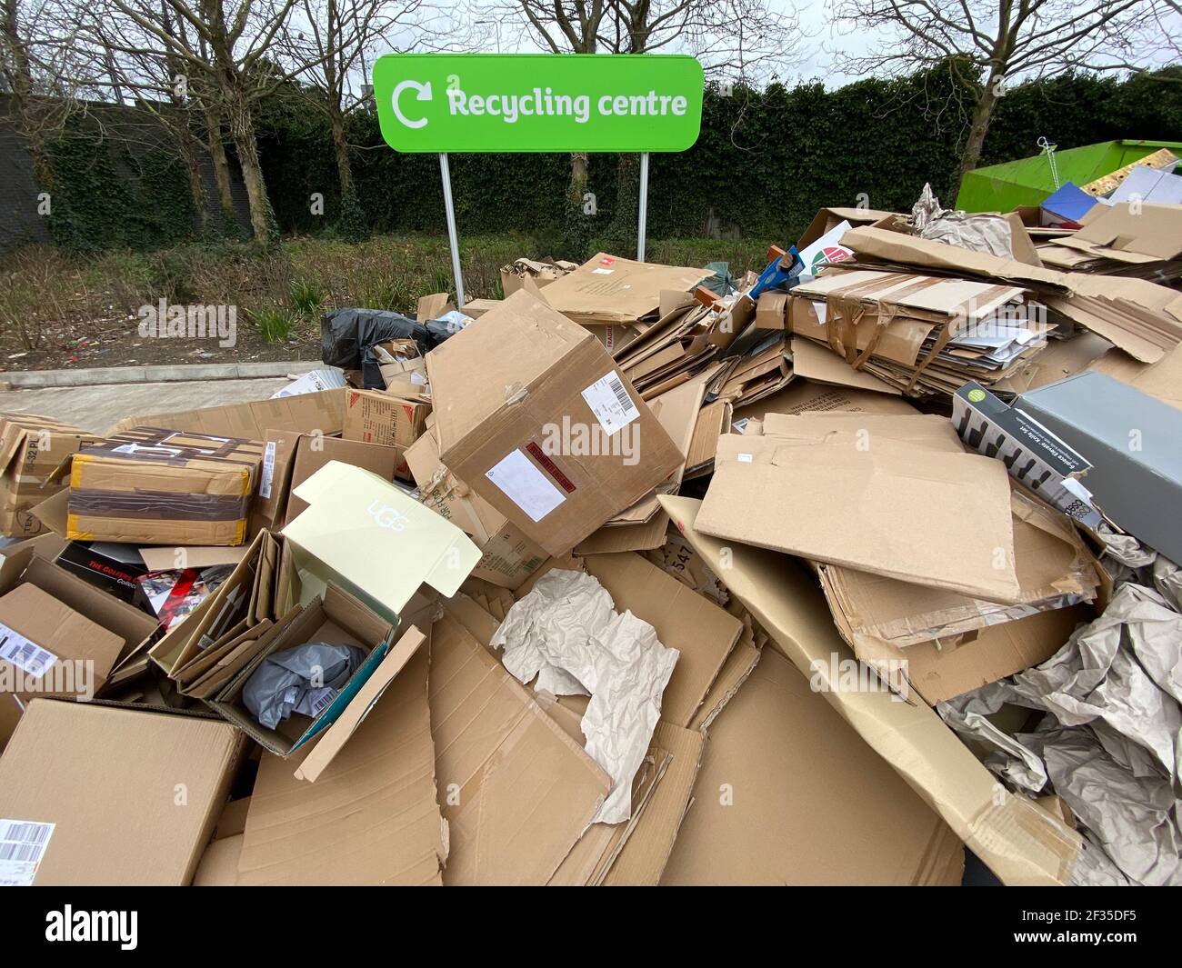 Cardboard boxes in front of a Recycling centre sign in a supermarket ...