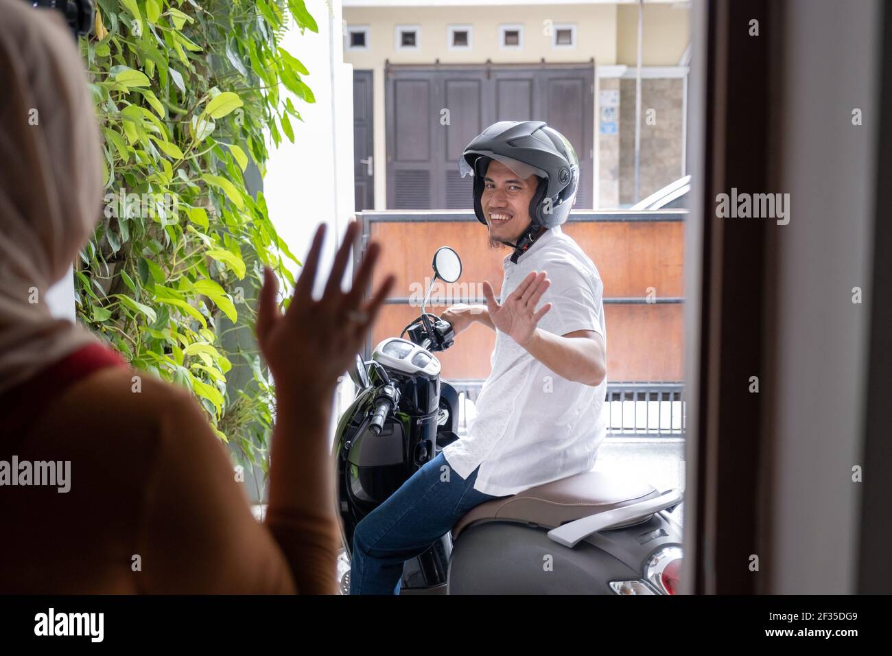 asian husband waving goodbye to his wife before leaving out by ...