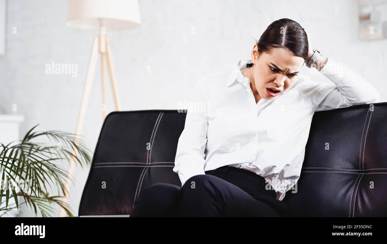 stressed businesswoman sitting on sofa in office Stock Photo - Alamy
