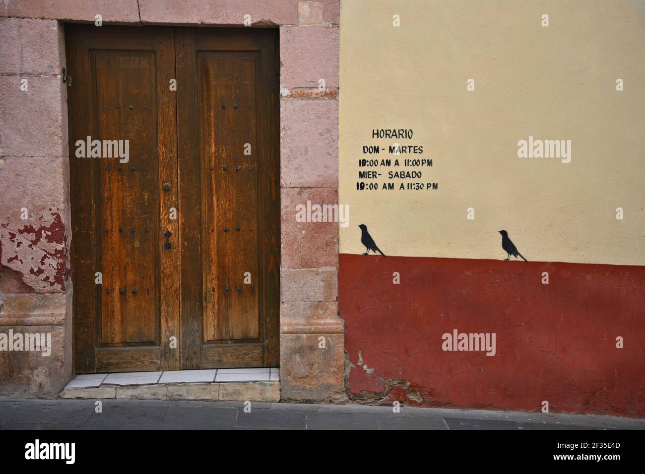 Facade view of a Colonial commercial building with a bi-colored stucco ...