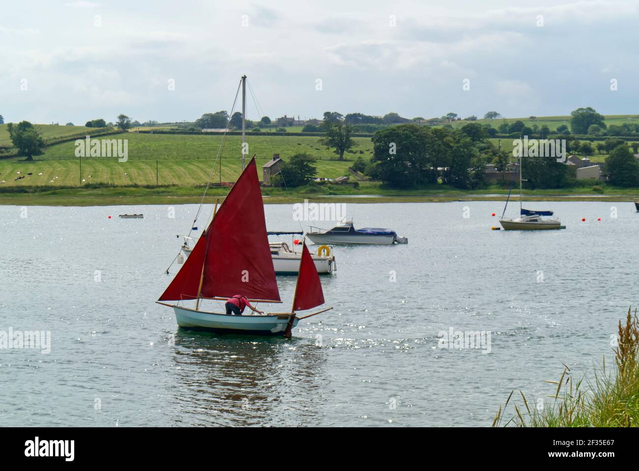 small gunter yawl rigged sailing boat with red sails in the River Aln ...