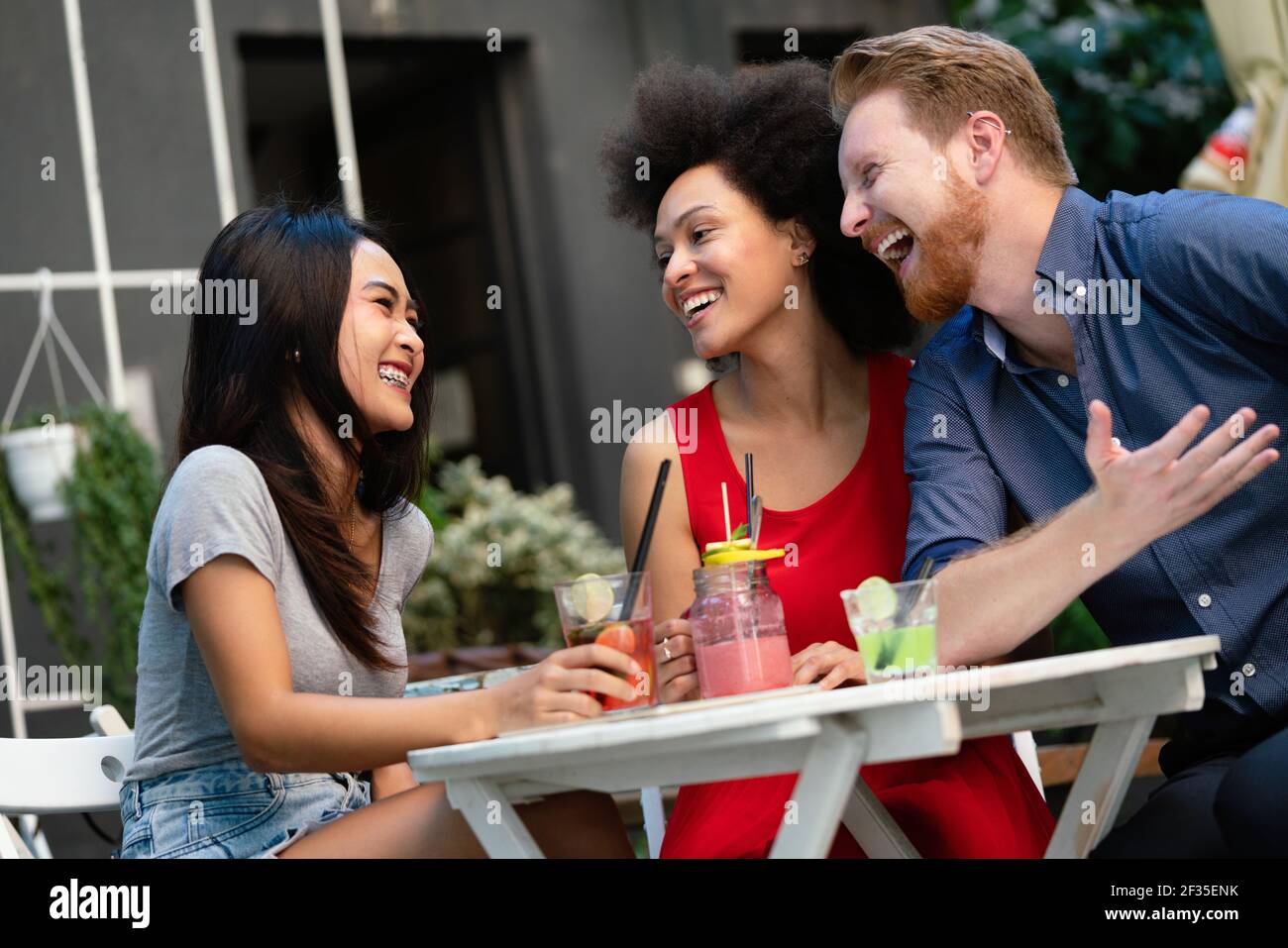Group of friends having fun together. People talking laughing and ...
