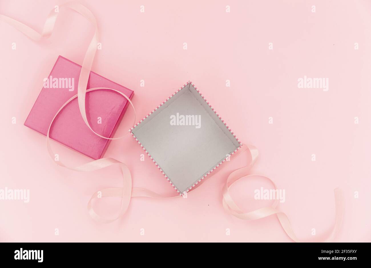 Gift box pink color on pink background. Package open and empty with ...