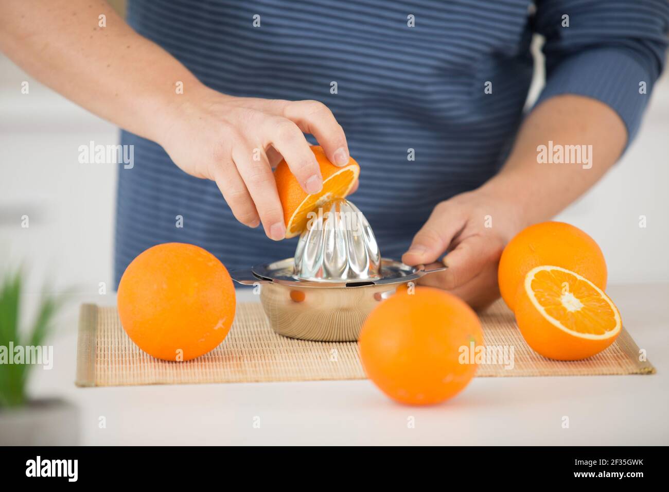 woman squeezing an orange fruit Stock Photo - Alamy