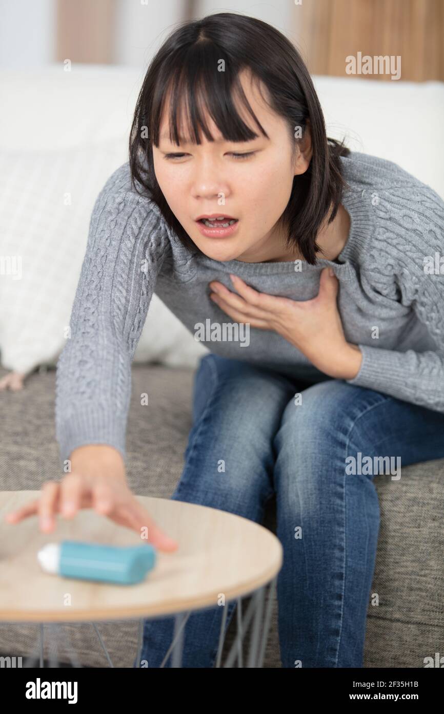 asian woman using a pressurized cartridge inhaler Stock Photo - Alamy