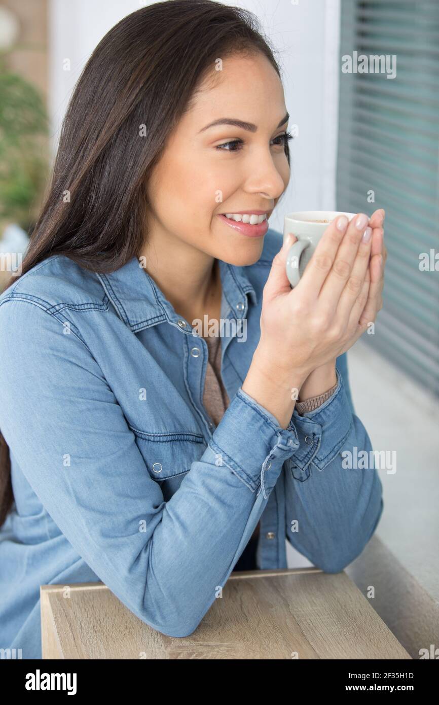 happy woman thinking and drinking coffee Stock Photo - Alamy