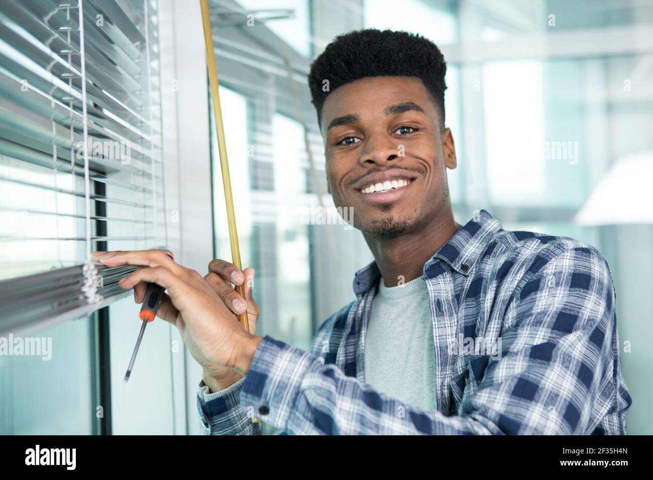 happy young man looking out the window Stock Photo - Alamy
