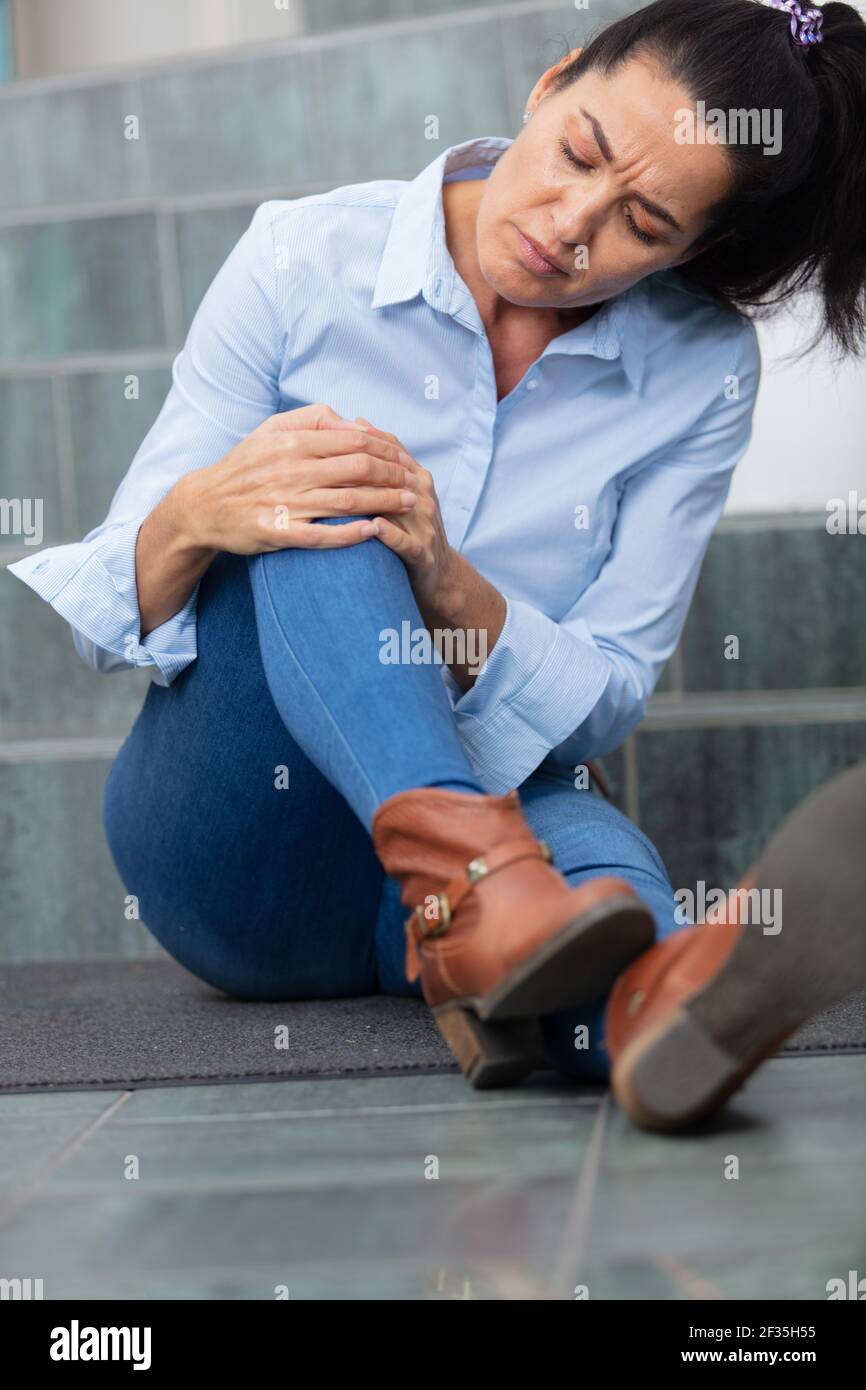 woman falling down from staircase has hurt her knee Stock Photo - Alamy