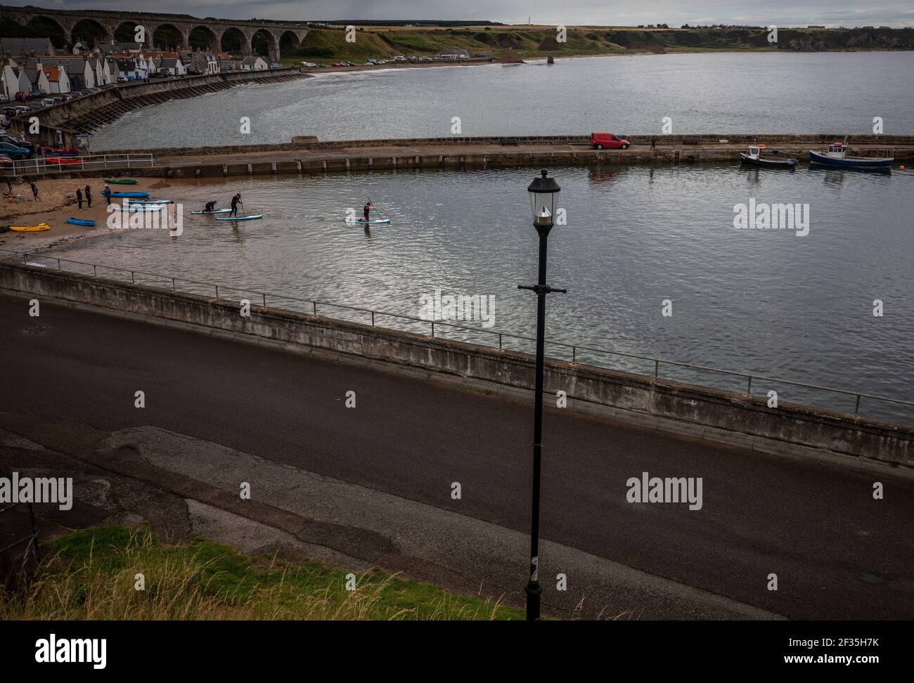 People take to bodyboards in Cullen harbour in Scotland Stock Photo - Alamy