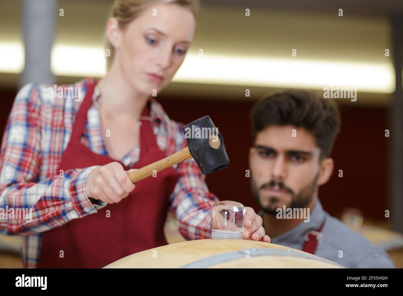 woman using a hammer to close a barrel Stock Photo - Alamy