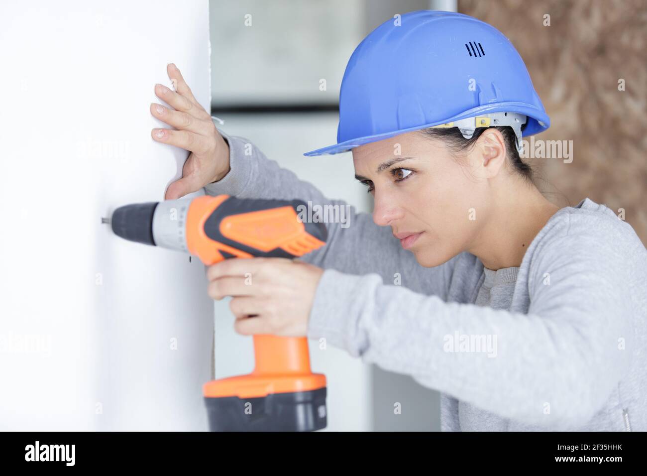 female carpenter at work using hand drilling machine Stock Photo - Alamy