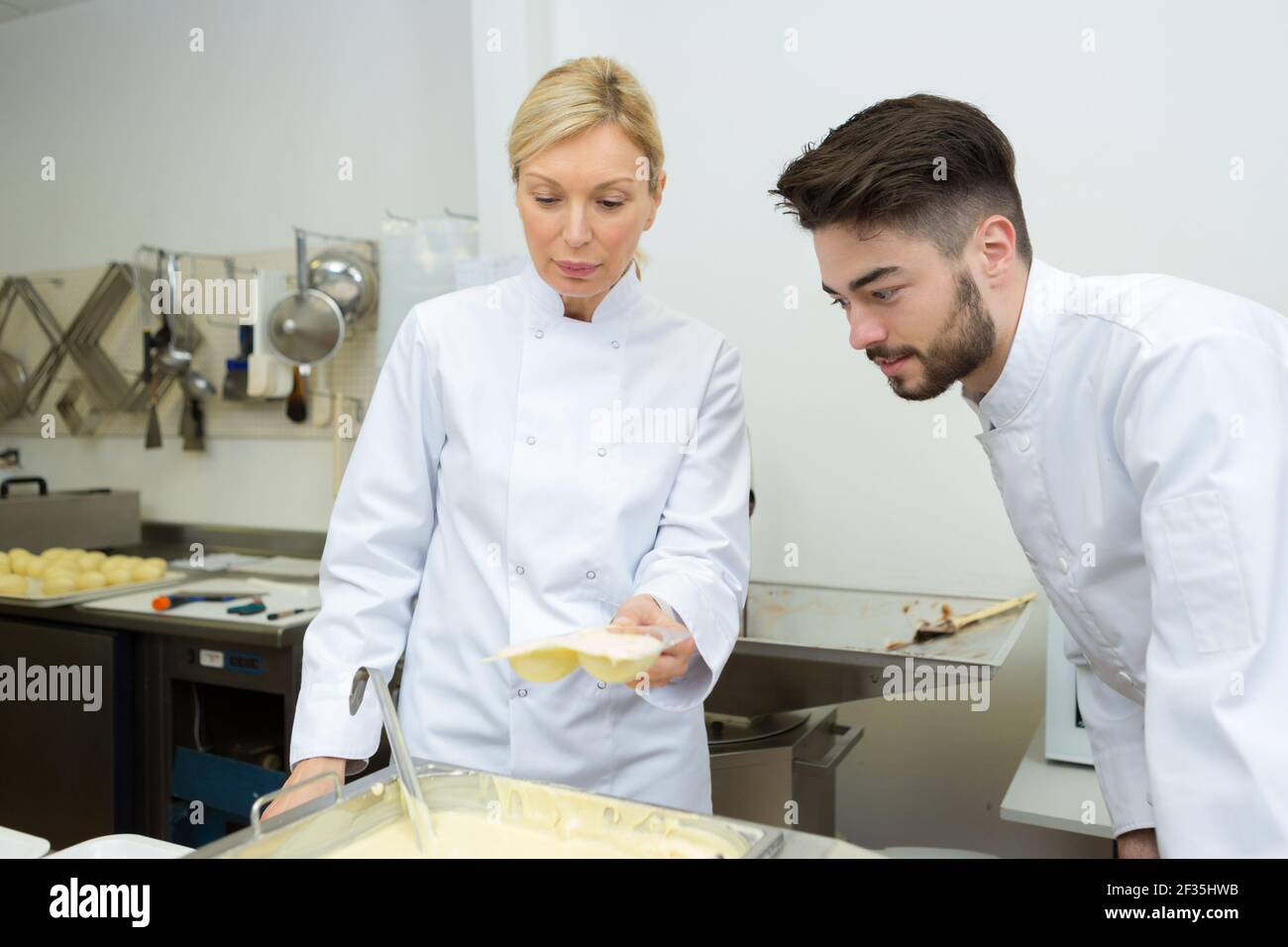 female chef making white chocolate eggs Stock Photo - Alamy