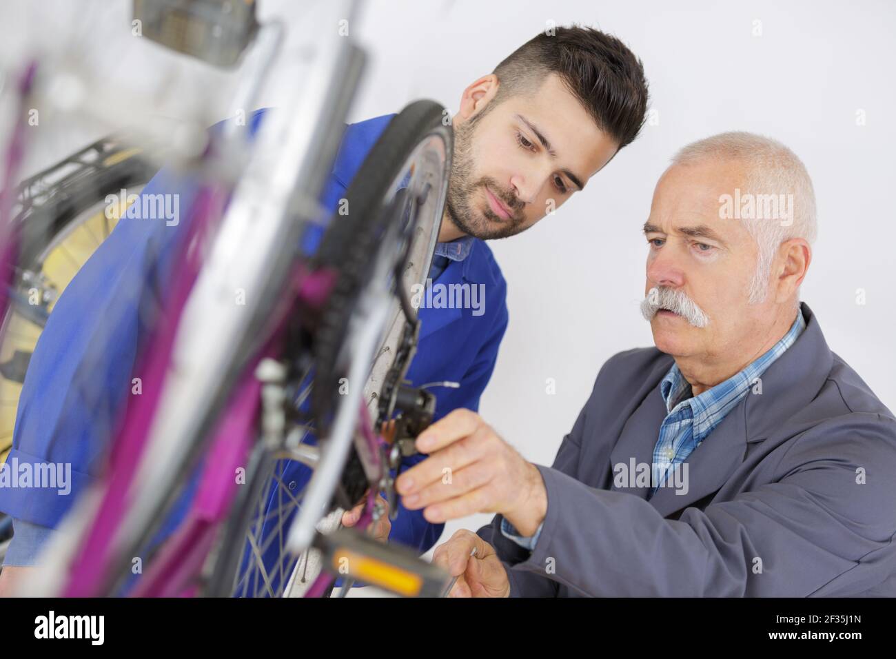 mechanic in training working on bicycle Stock Photo - Alamy