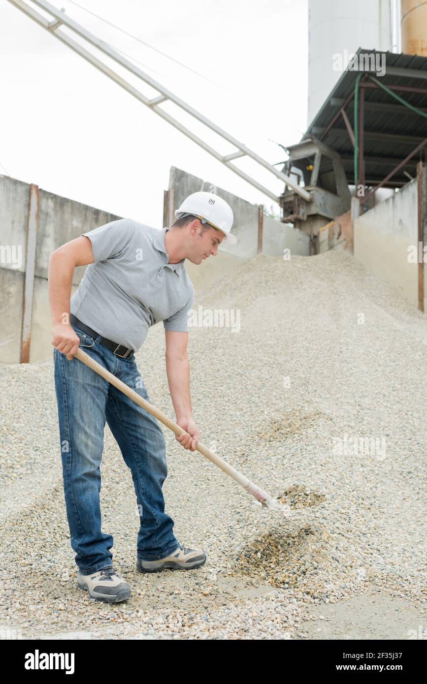 man digging the footpath ground with shovel Stock Photo - Alamy