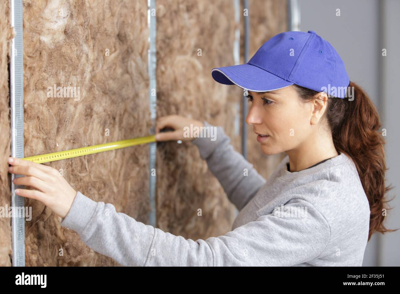woman is measuring a wall Stock Photo - Alamy