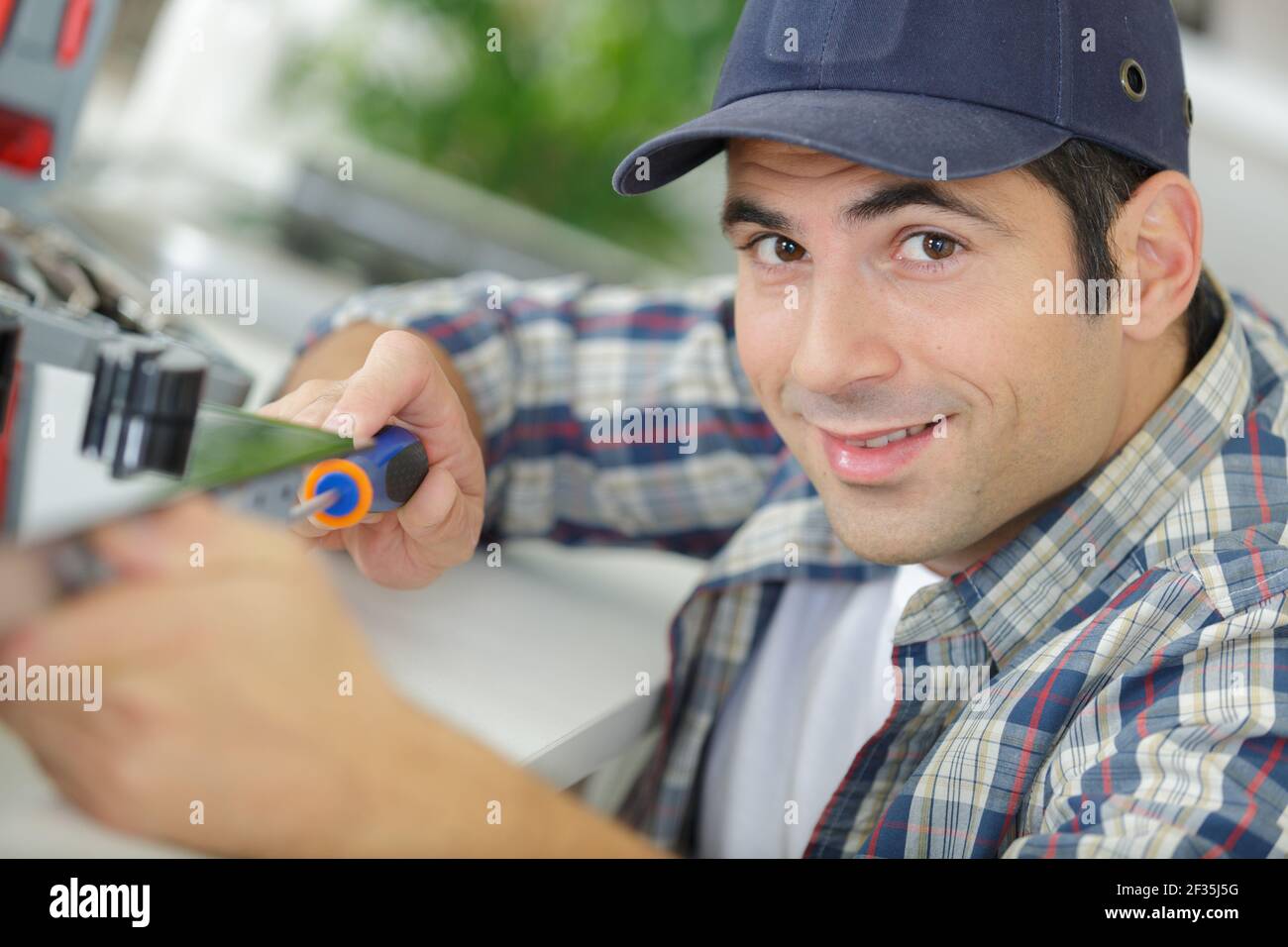 happy man screwing screws into furniture fittings Stock Photo - Alamy