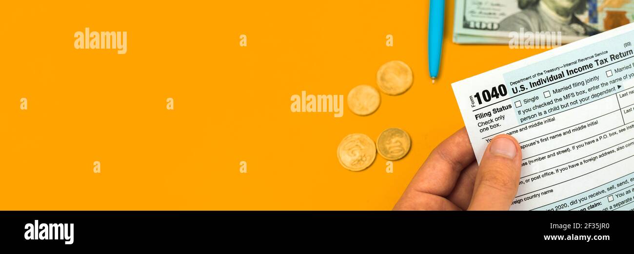 Man hand holds tax form 1040, income and return concept, business ...