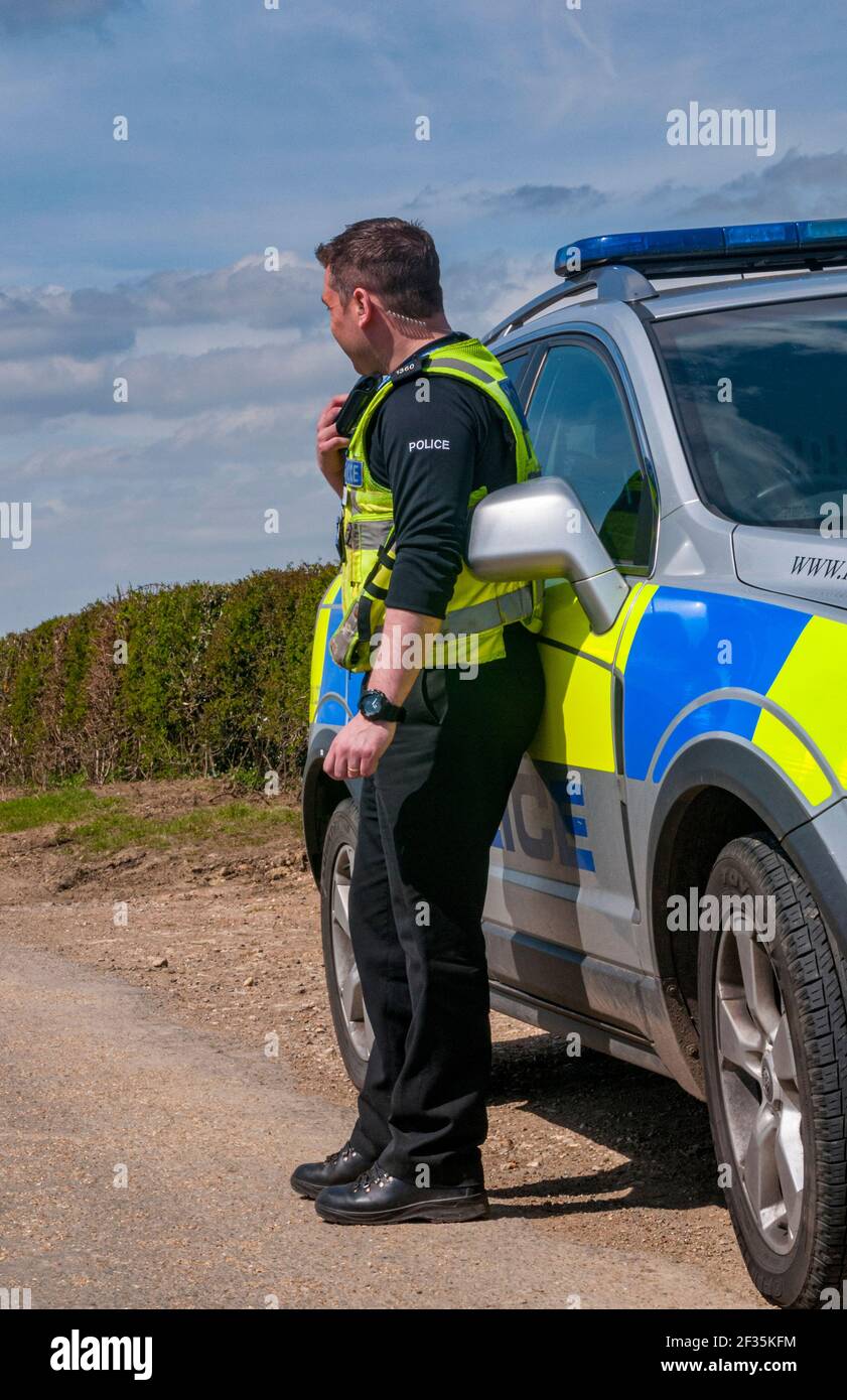 Northamptonshire, England, UK. A policeman with police 4x4 vehicle ...