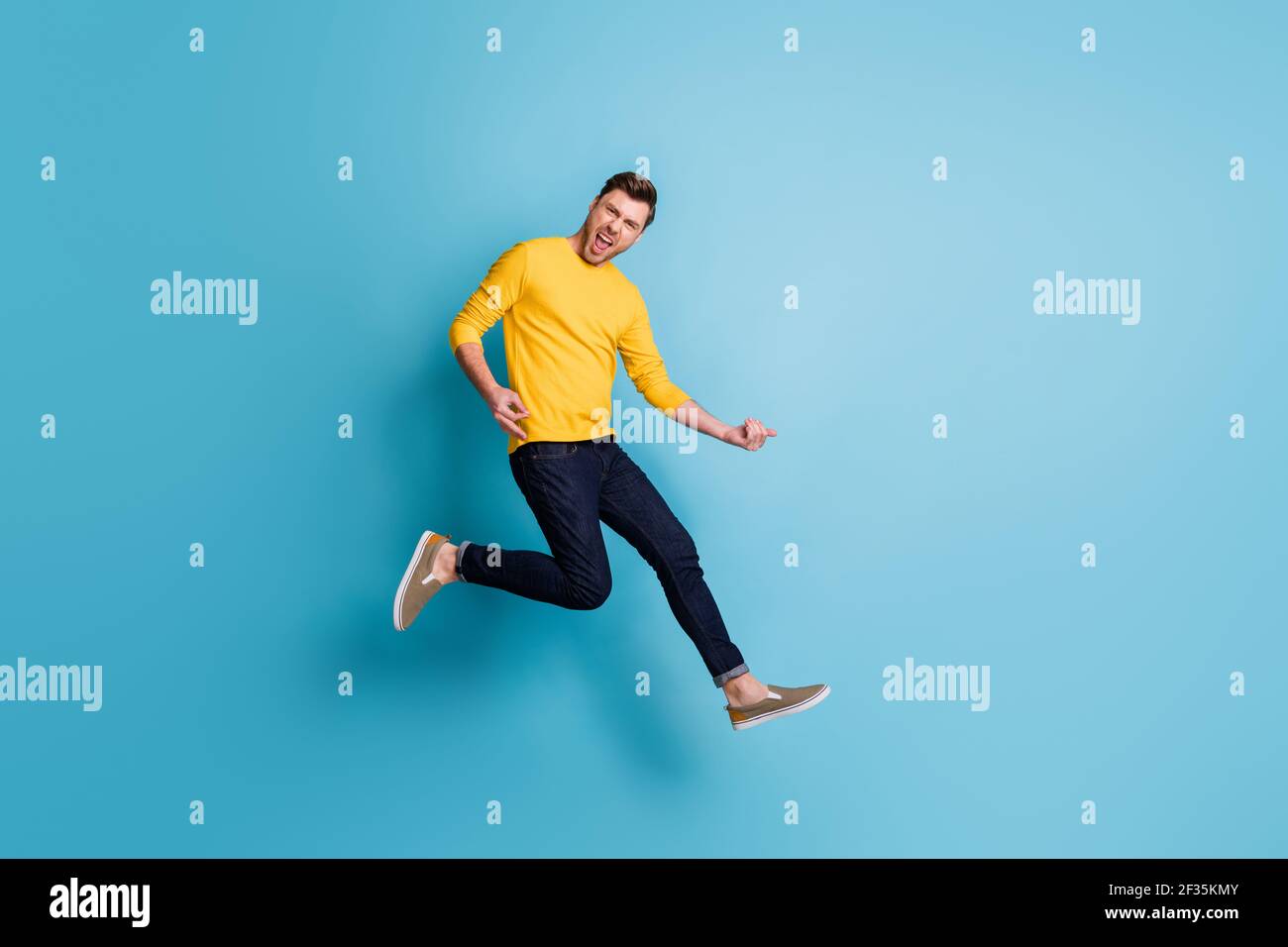 Full size photo of funky man jump up air play imagine guitar isolated ...