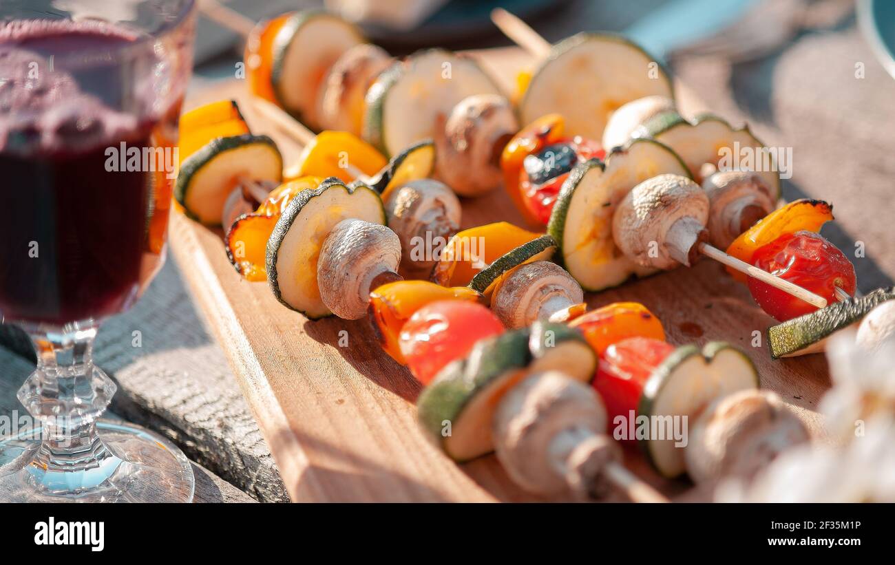 Vegetarian skewer of zucchini, tomato and sweet pepper on a wooden ...