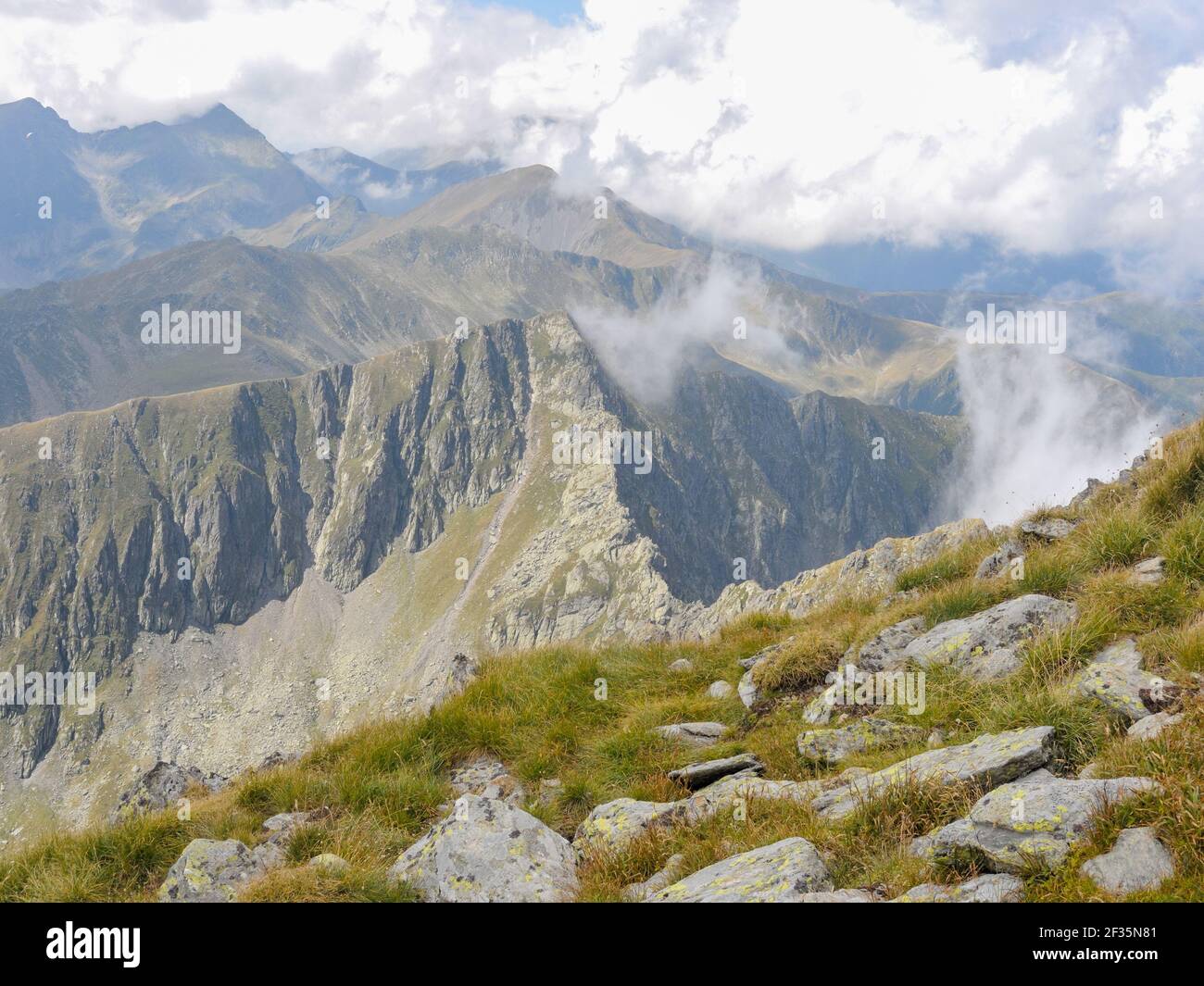 A mesmerizing view of Fagaras mountains under a cloudy sky in Romania ...