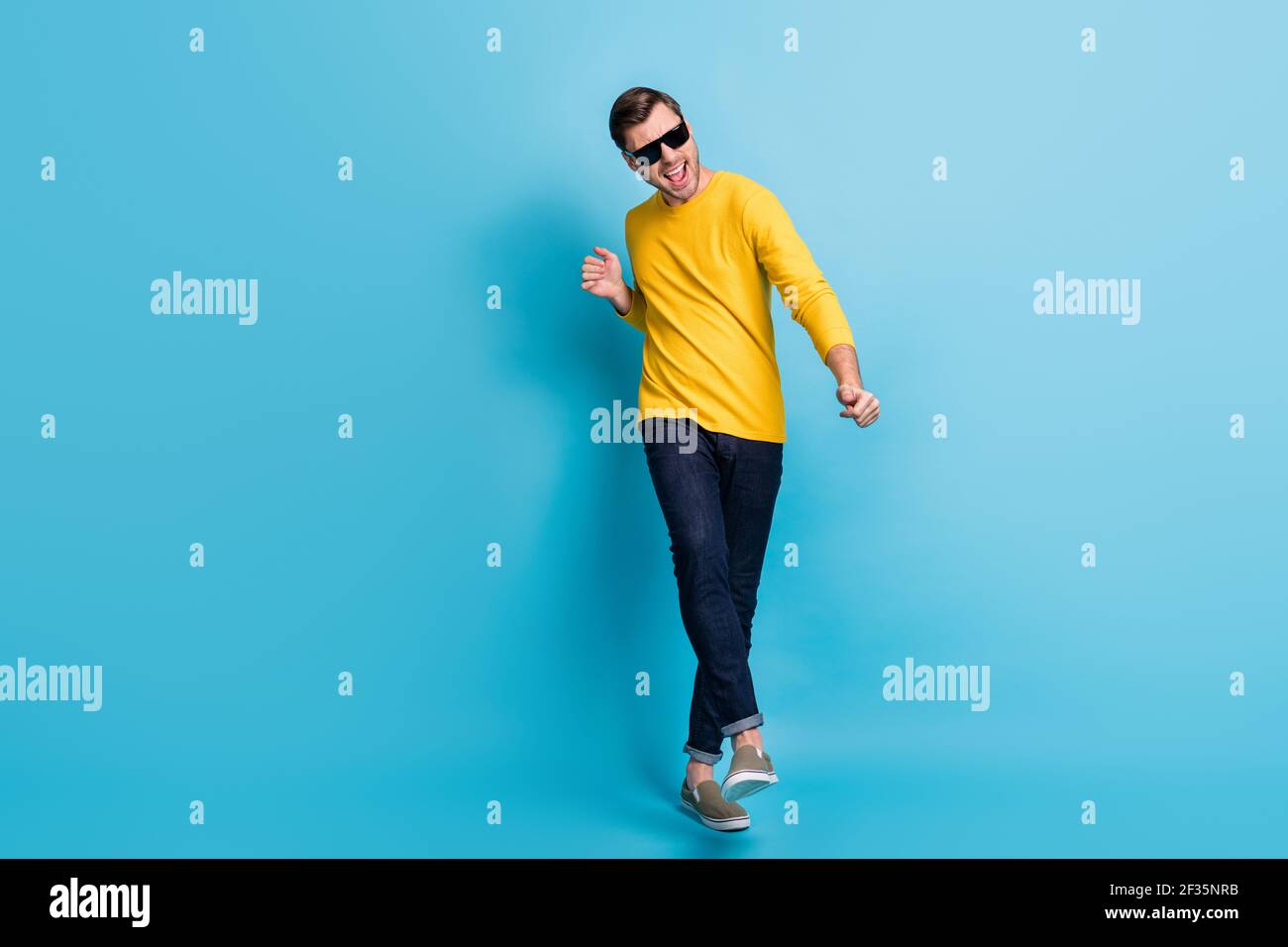 Full body portrait of positive ecstatic young guy dancing partying open ...