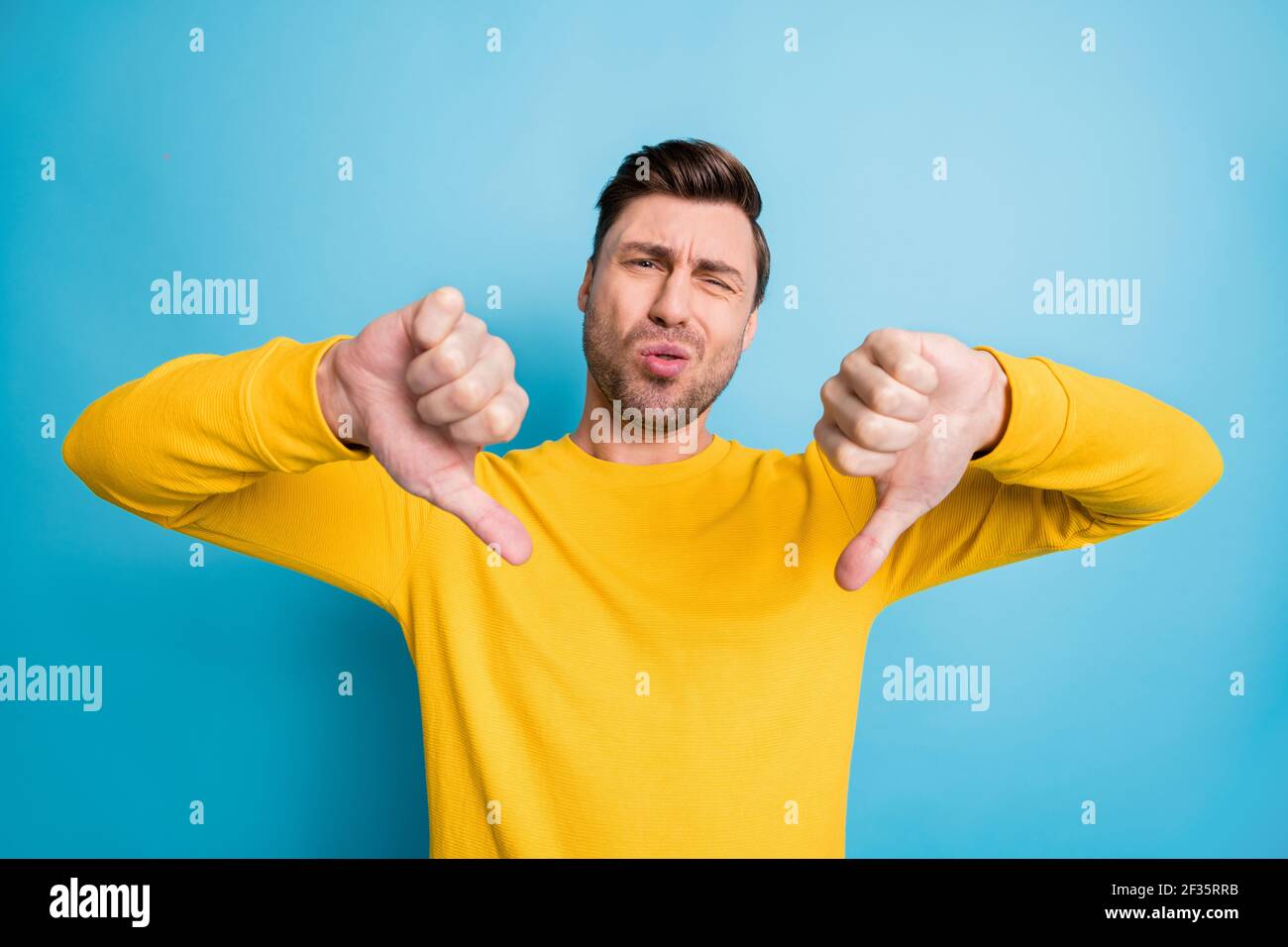 Photo of unsatisfied person sullen face show two hands thumbs down ...