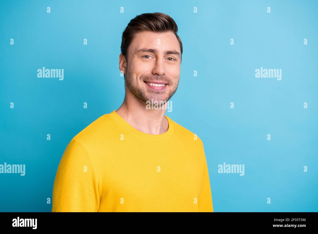 Profile portrait of half turned young man smile look camera isolated on ...