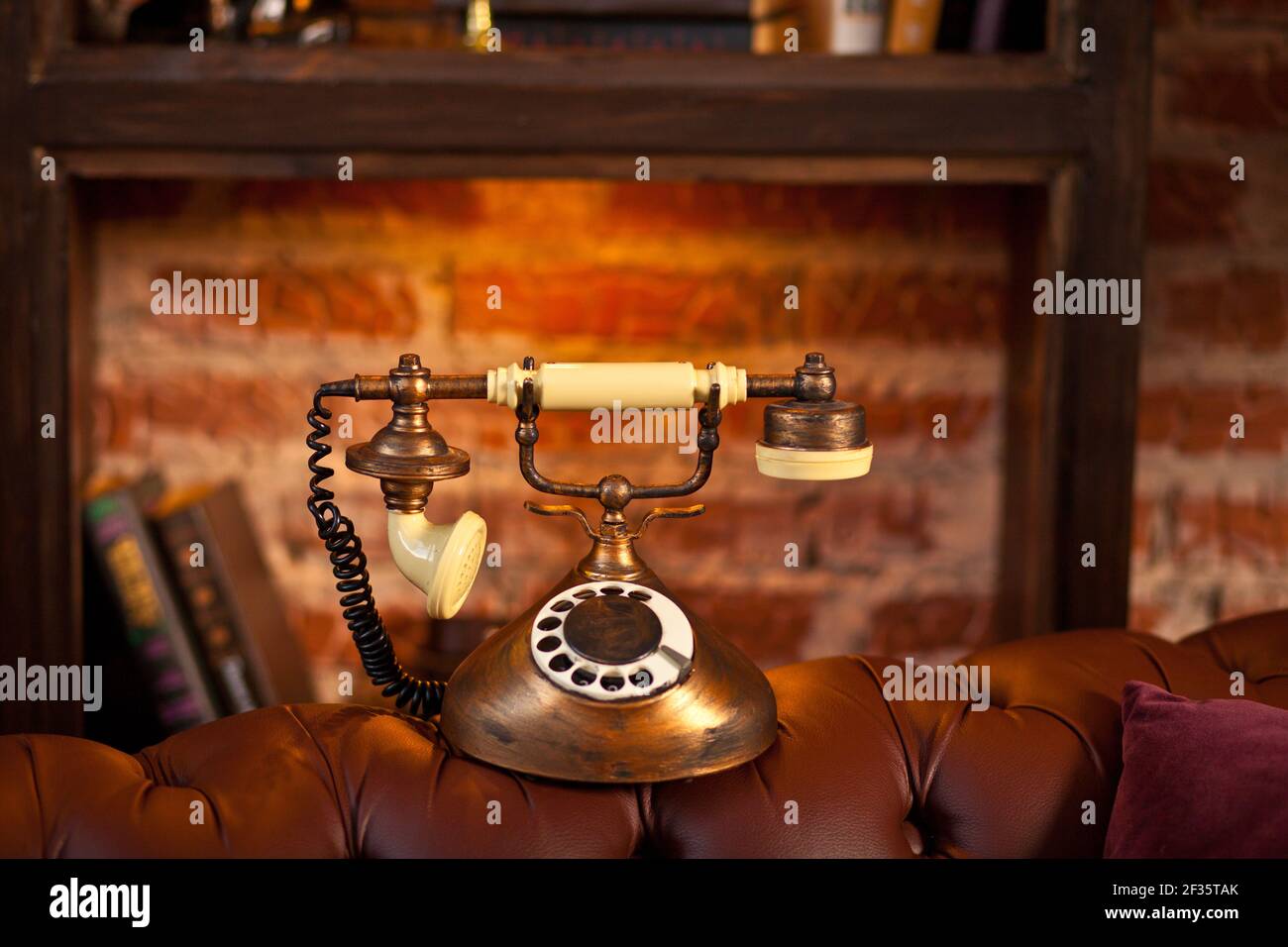 Vintage retro phone with rotary dial in interior on the brick wall and ...