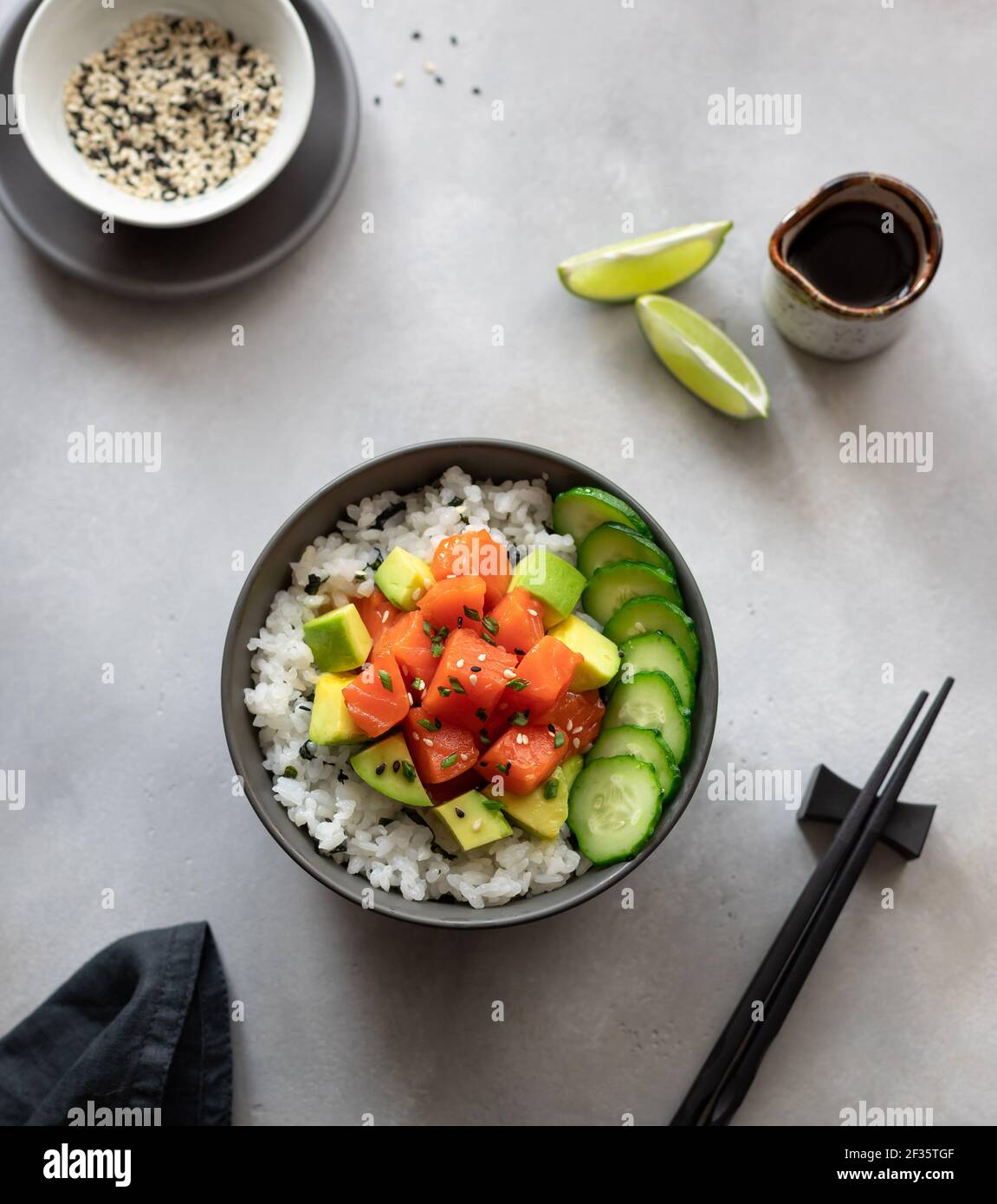 Hawaiian salmon fish poke bowl with avocado, cucumber and rice on a ...