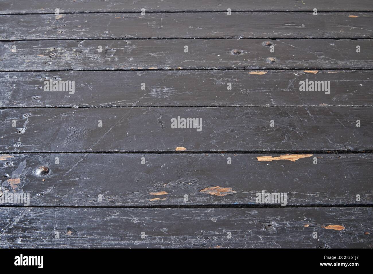 Weathered rustic and grungy black plank from table in perspective view ...
