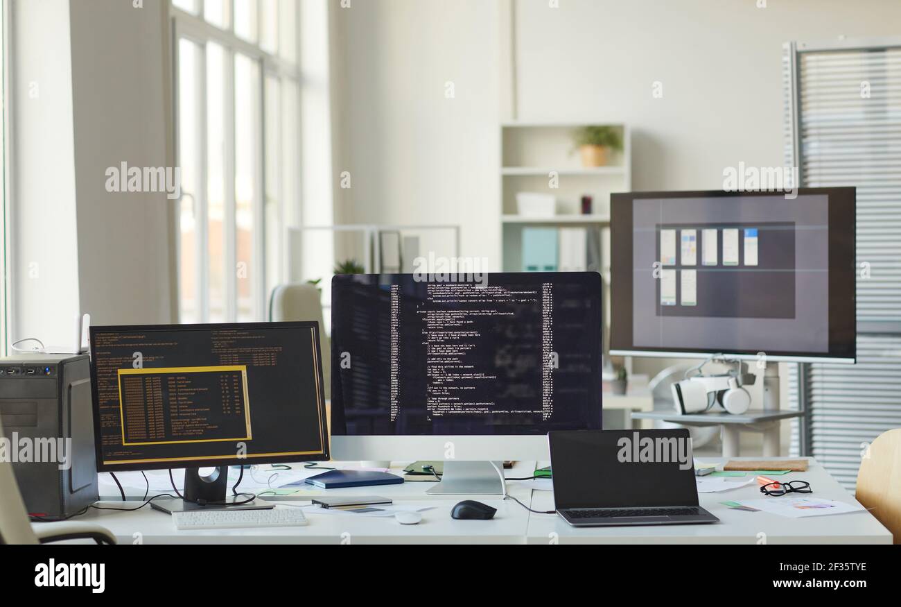 Background Image Of Several Computer Screens With Code Lines On Desk In It Programmers Office