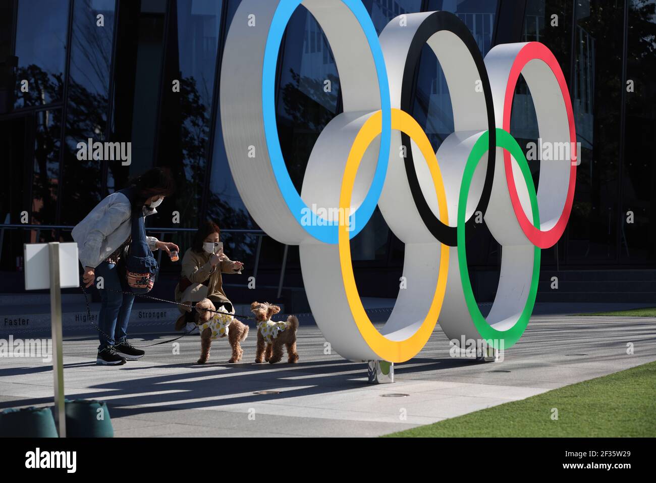 Tokyo, Japan. 15th Mar, 2021. Women take photos of their dogs in front ...