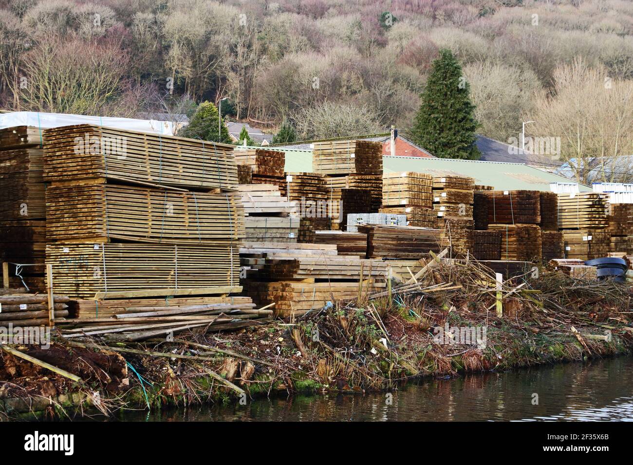 Stacks of timber outside agricultural supply company Stock Photo - Alamy