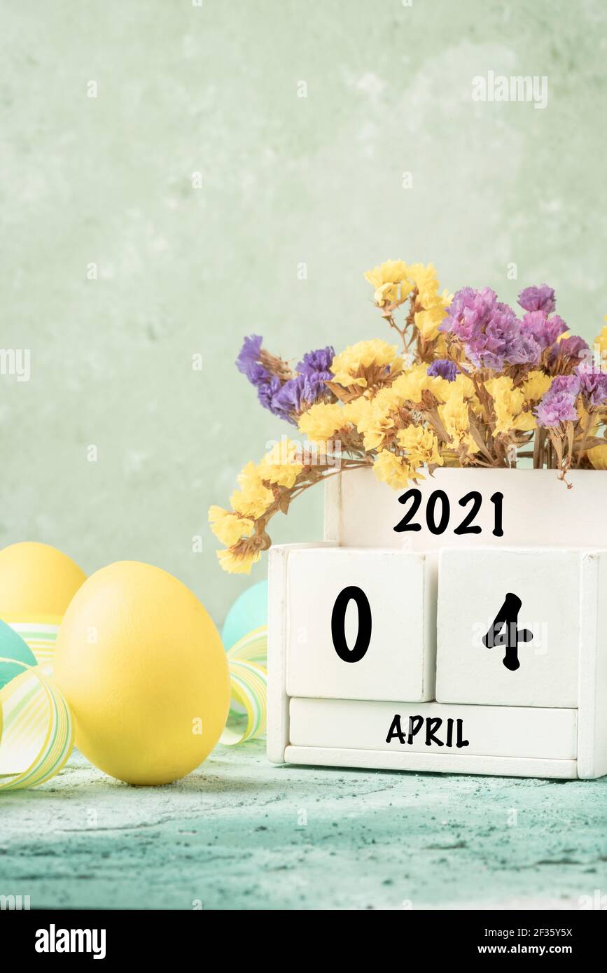 easter template with colorful eggs and cube calendar over green with ...